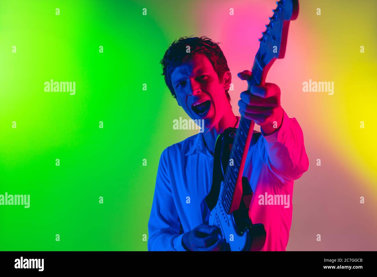 Close up. Young caucasian inspired and expressive musician, guitarist ...