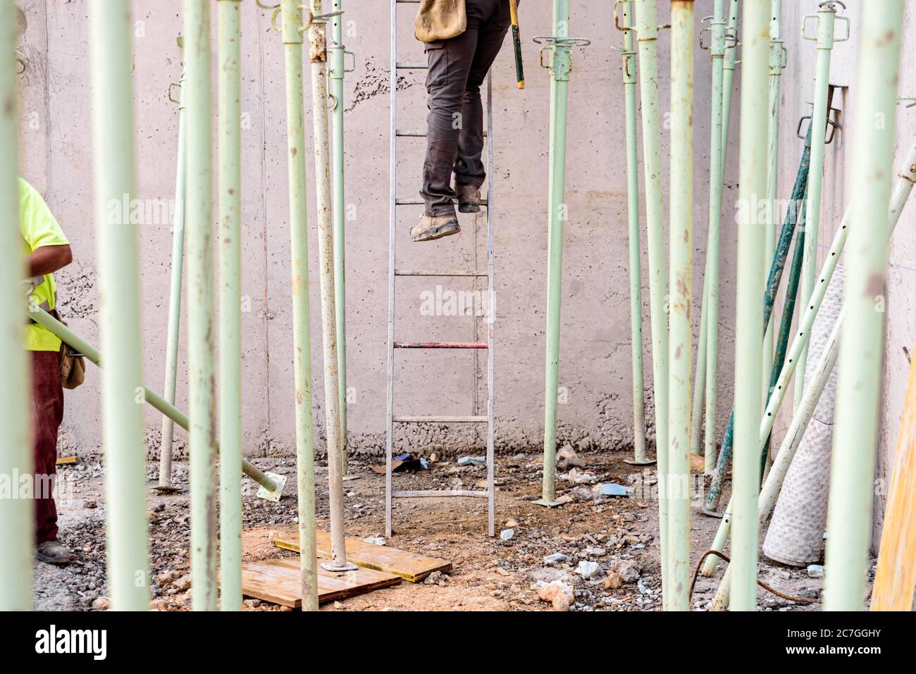 Workers placing support bars to cement the structure of a building with ...