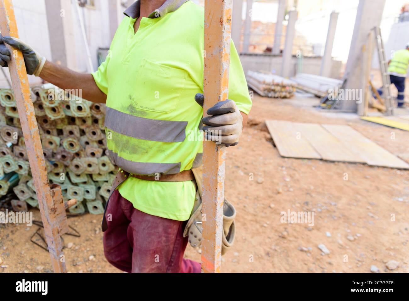 Unrecognizable construction worker working on a construction site with ...
