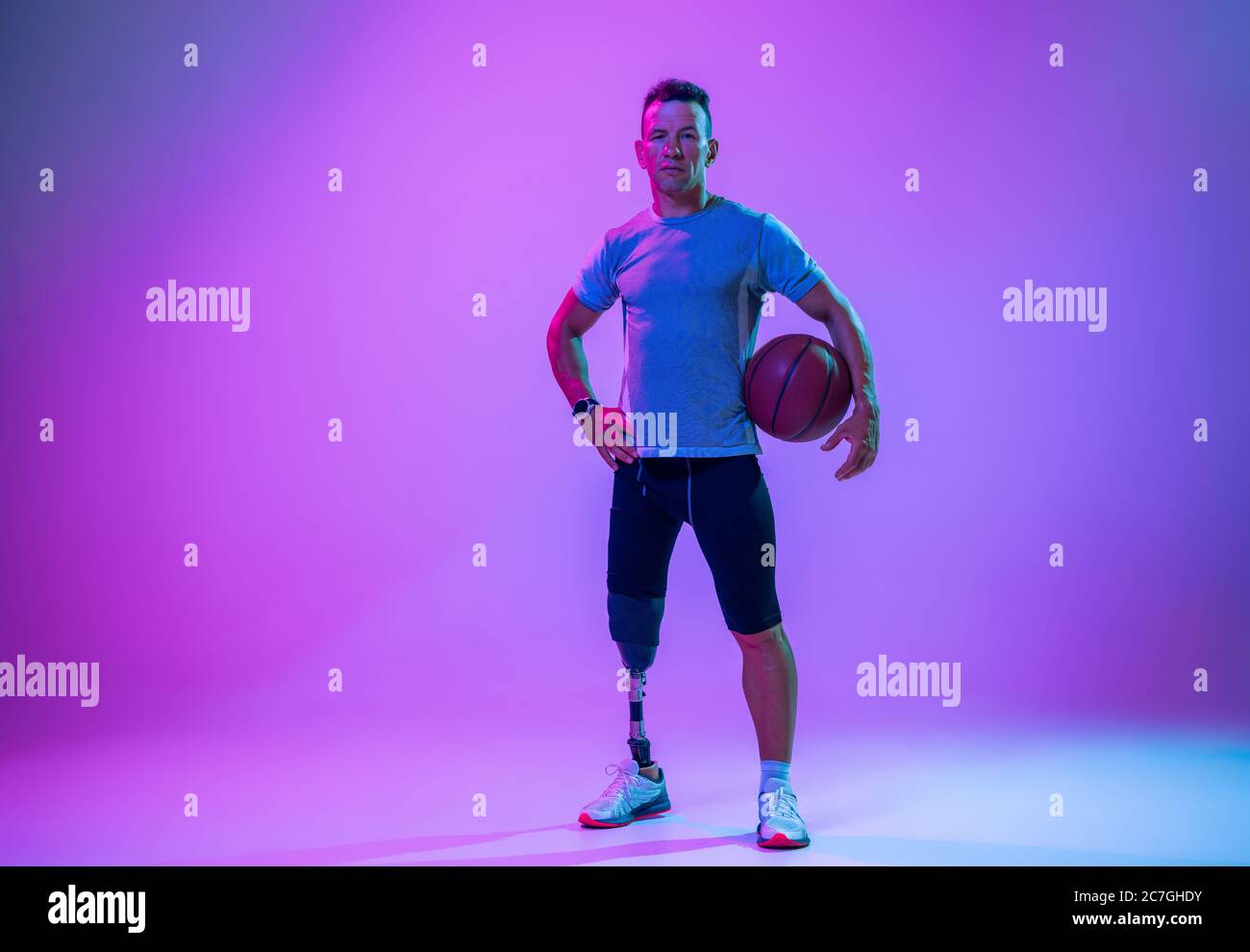 Athlete with disabilities or amputee on gradient studio background in ...
