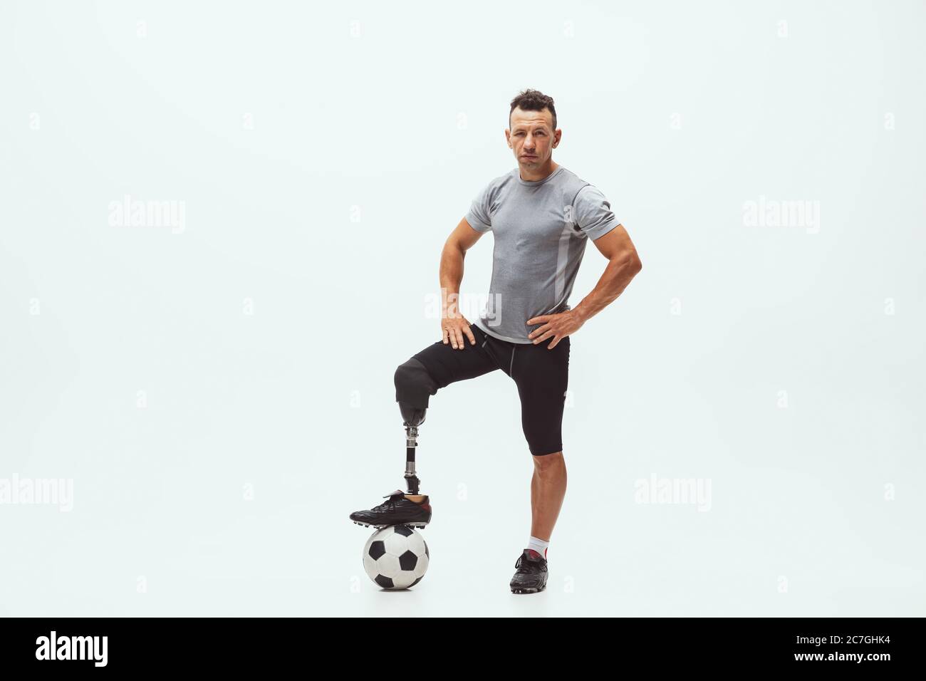 Athlete with disabilities or amputee on white studio background ...