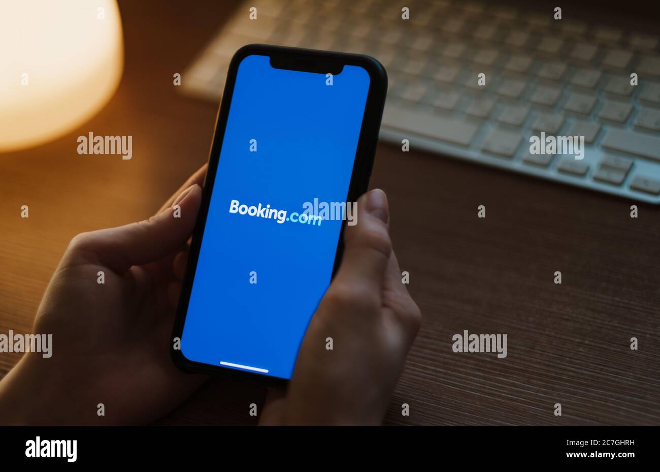 Woman use booking app, booking com logo on the smartphone screen Stock ...