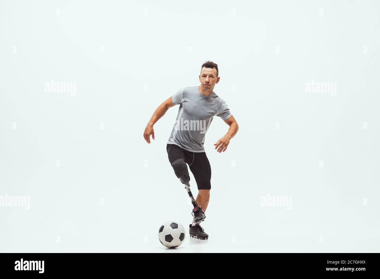 Athlete with disabilities or amputee on white studio background ...