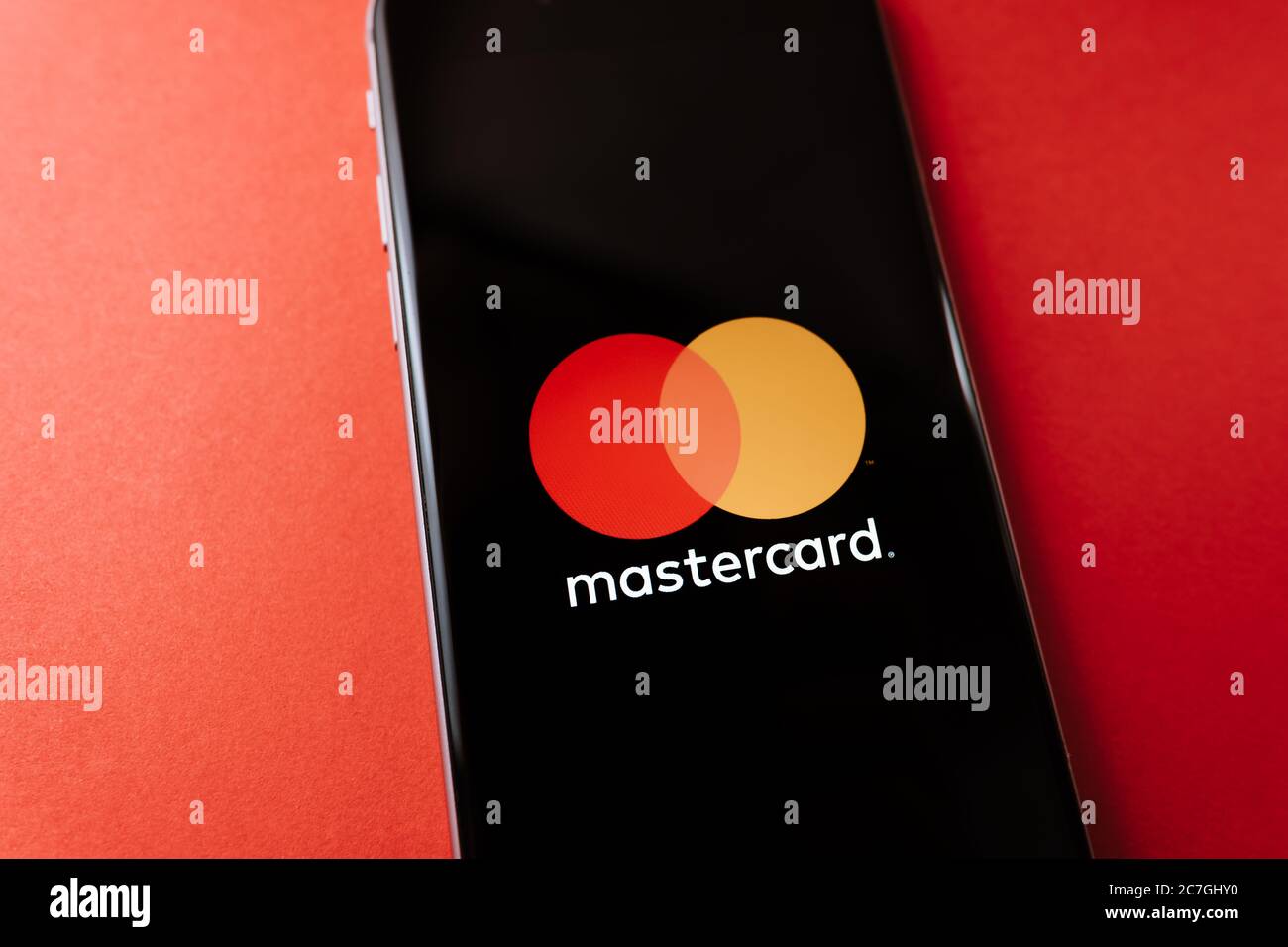 MasterCard logo on the smartphone screen, on red background Stock Photo ...