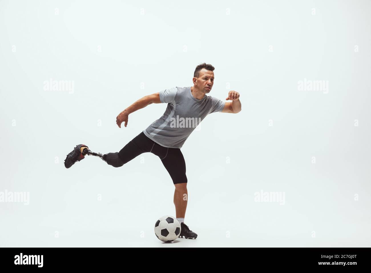 Athlete with disabilities or amputee on white studio background ...