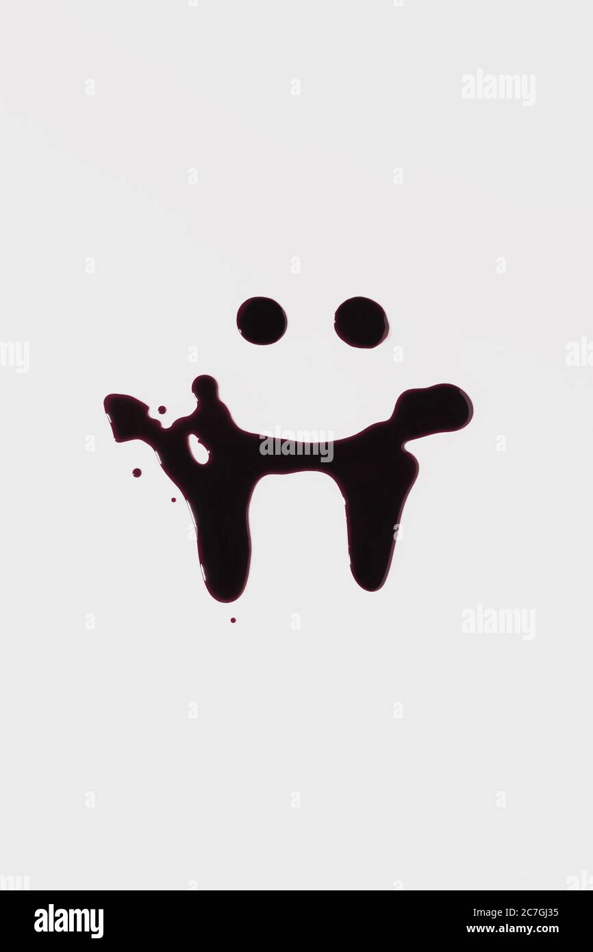 Smiling face with vampire teeth drawn in fake blood on white background ...