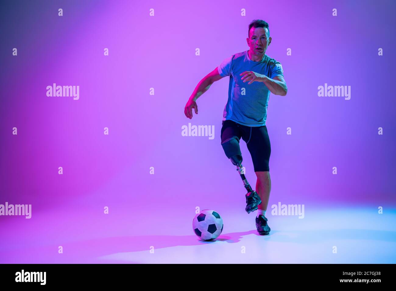 Athlete with disabilities or amputee on gradient studio background in ...