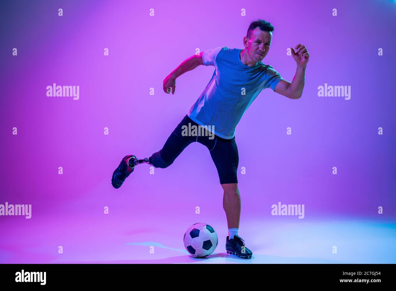 Athlete with disabilities or amputee on gradient studio background in ...