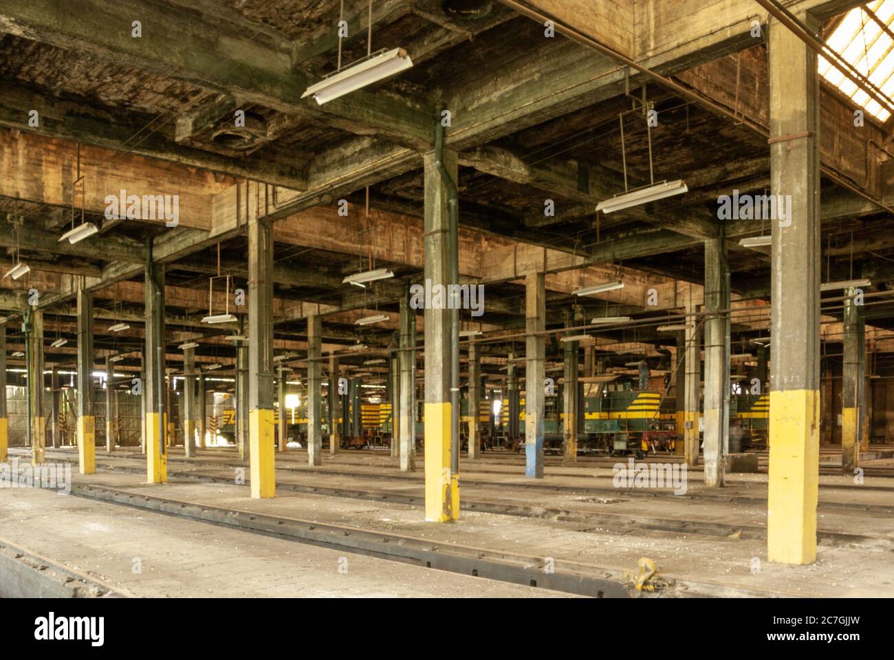 Interior shot of an old warehouse with old trains inside Stock Photo ...