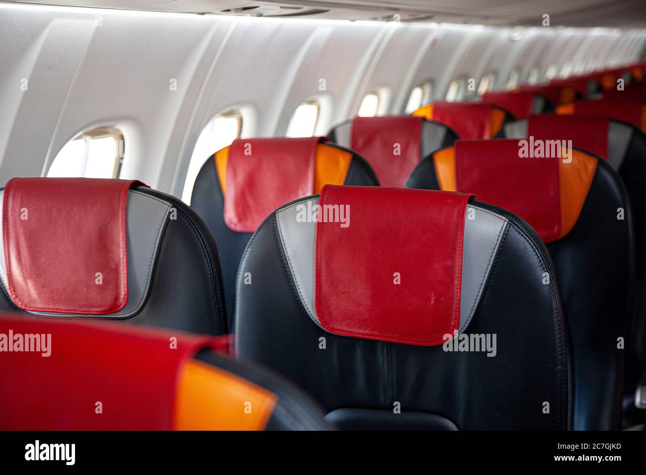 Empty cabin of the plane. Soft seats for passengers, portholes. Inside ...