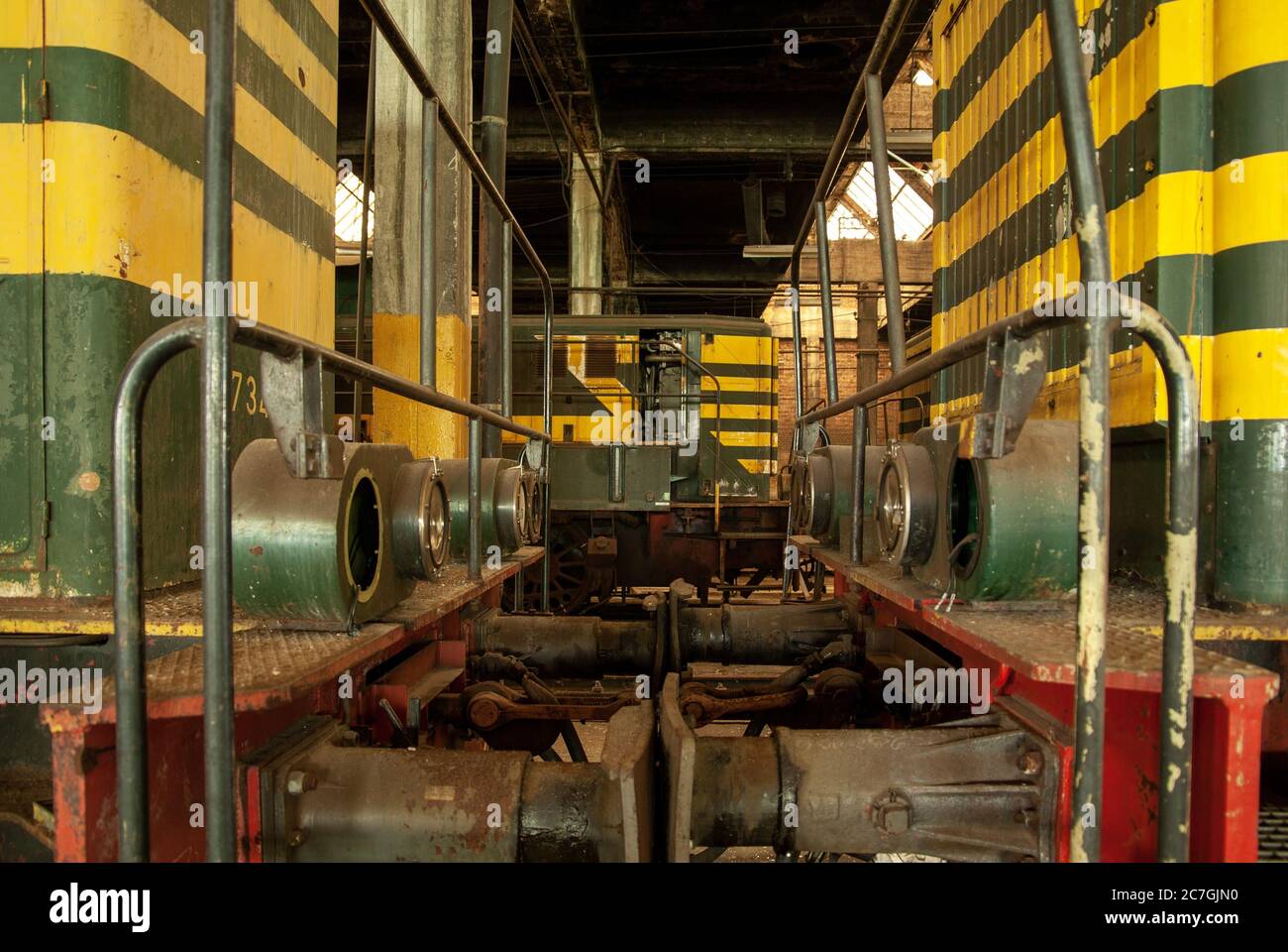 Interior shot of an old abandoned warehouse with old trains inside ...