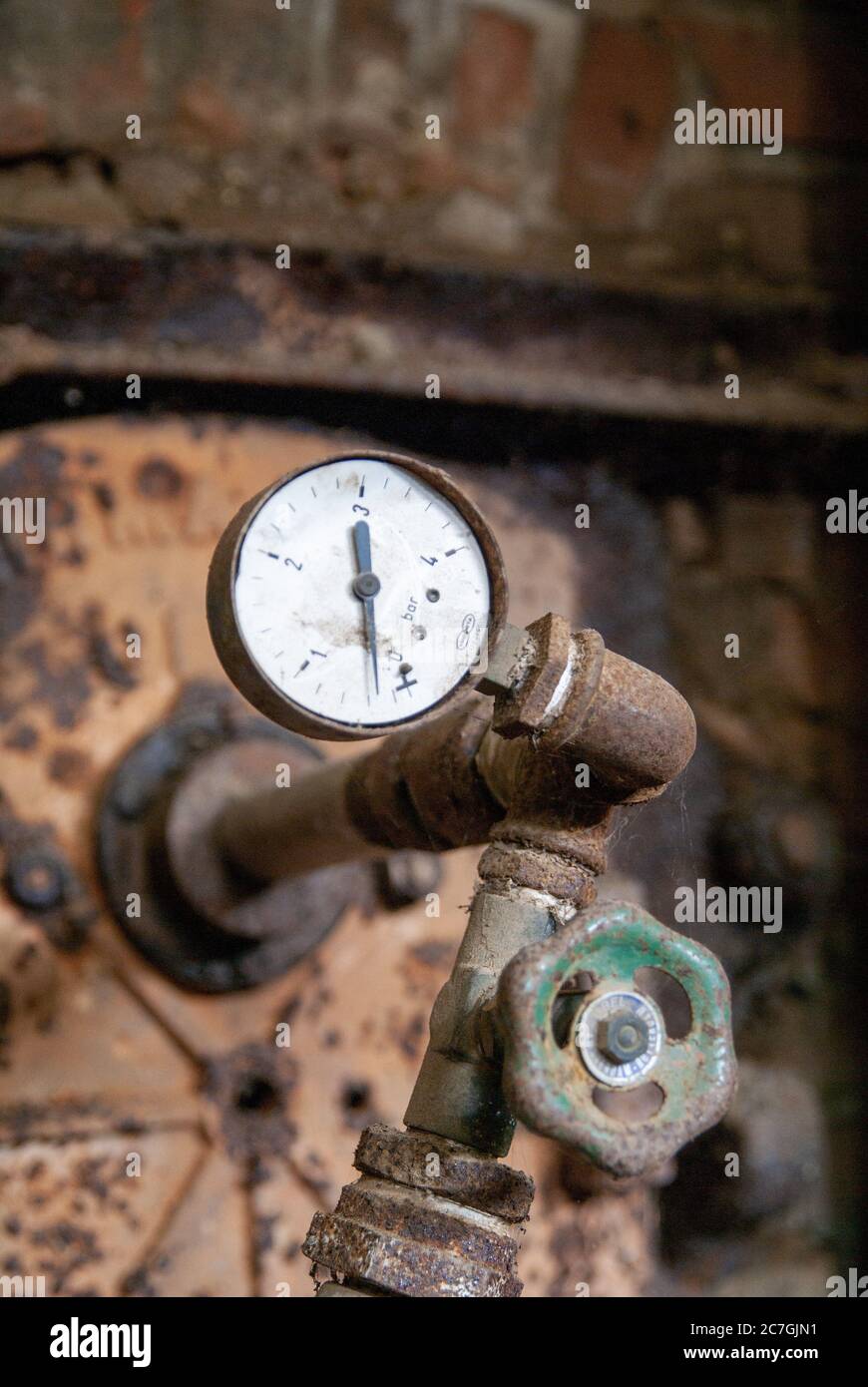 Vertical shot of a pressure gauge on a rusty metal tube Stock Photo - Alamy
