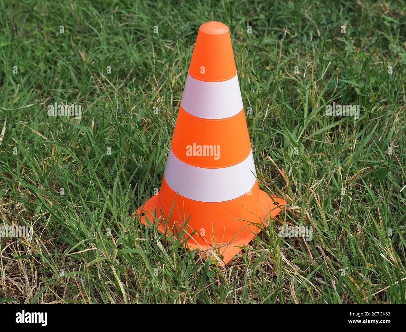 white and orange traffic cone to mark road works Stock Photo - Alamy