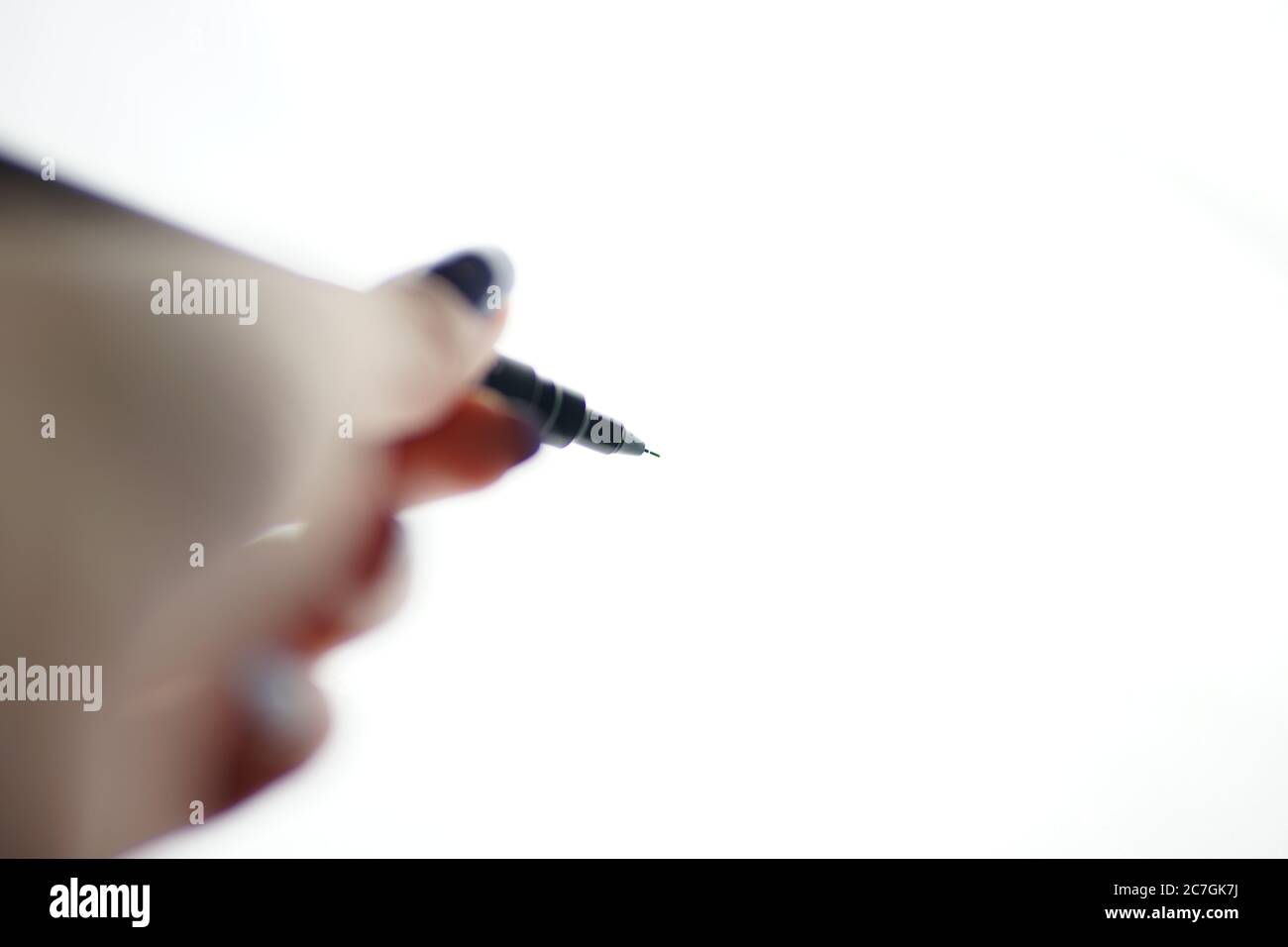 Pen in a female hand on a white background. Side view, isolated ...
