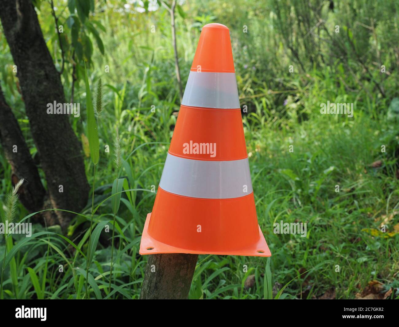 white and orange traffic cone to mark road works Stock Photo - Alamy