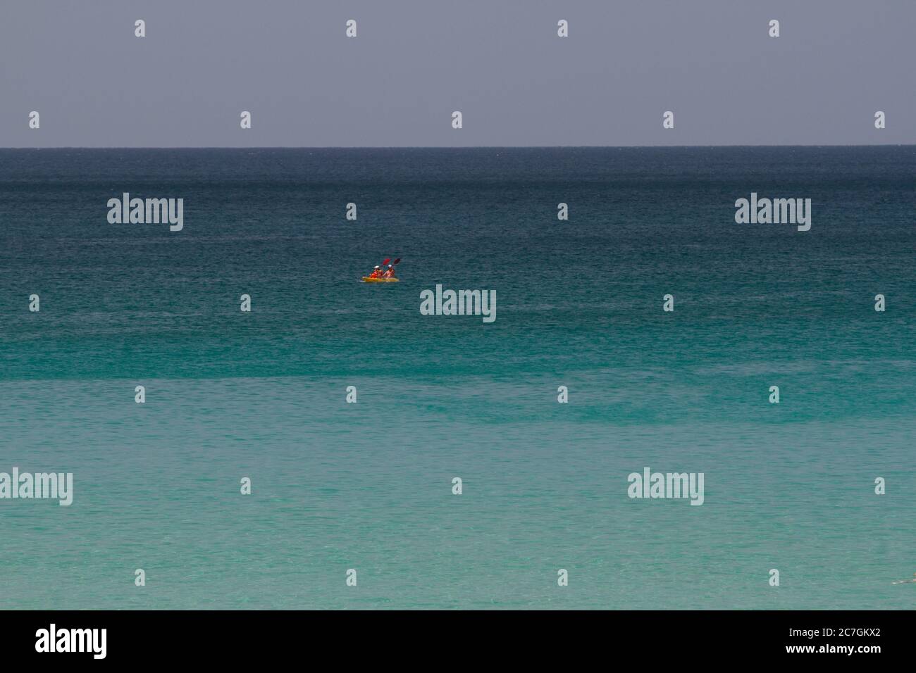 Beautiful shot of the sea with two people in the raft in the distance ...