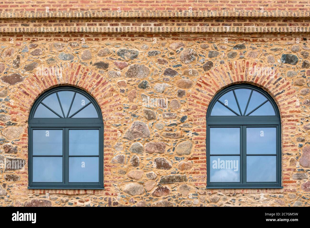 Modern plastic windows in the old brick building Stock Photo - Alamy