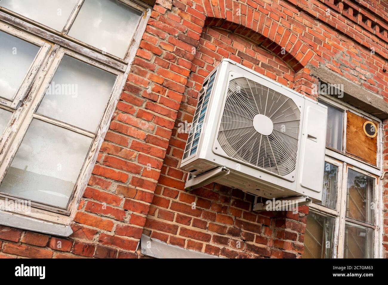Air conditioning unit on the facade of a old red brick house Stock ...
