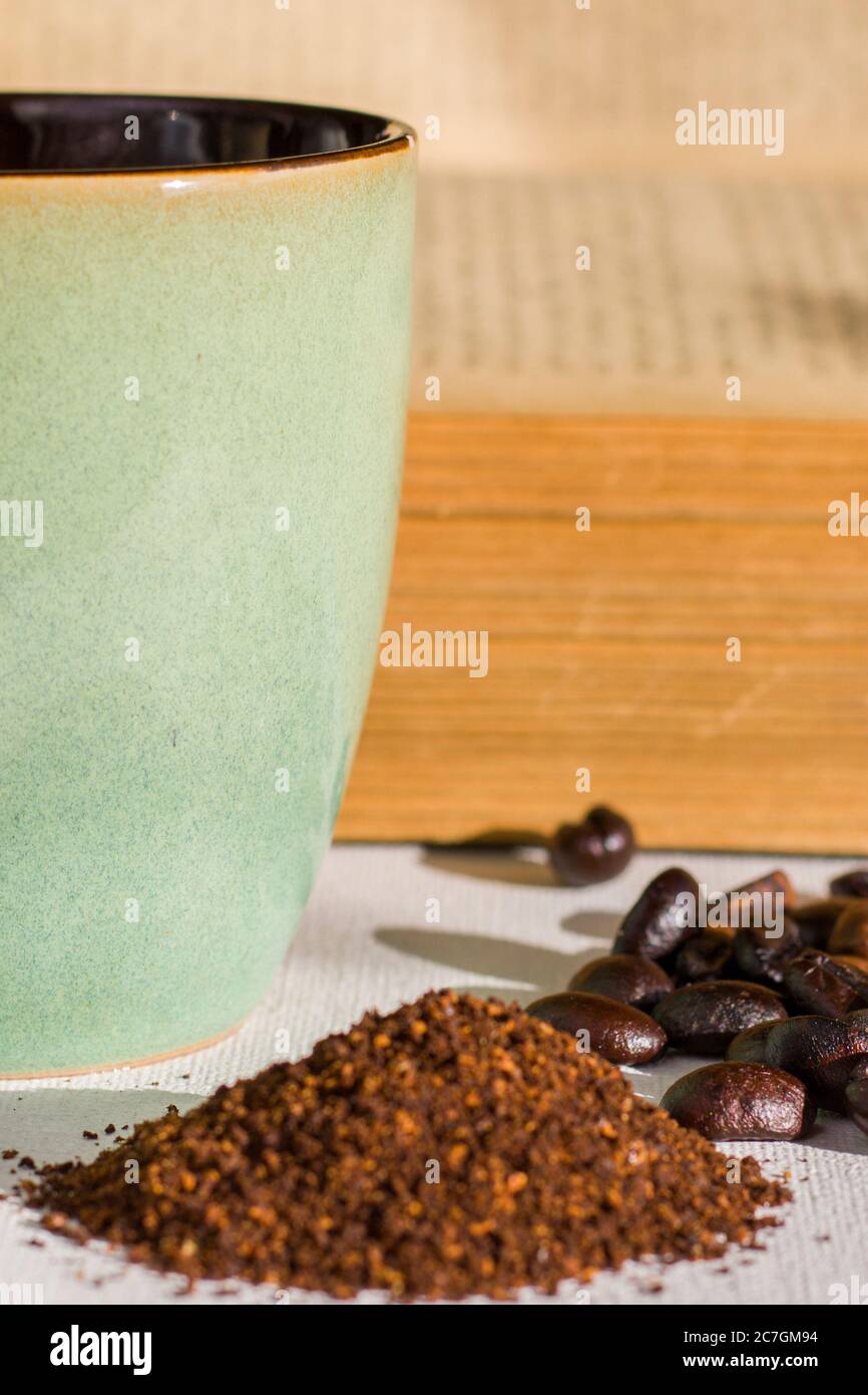 Roasted coffee beans and grained coffee seeds, studio shot, book and ...