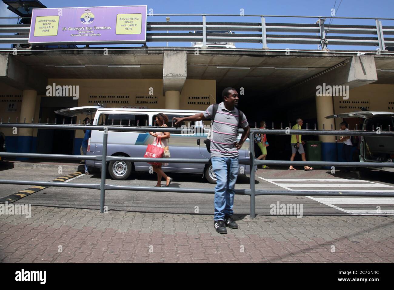 St George's Grenada man waiting by Bus Station Stock Photo - Alamy