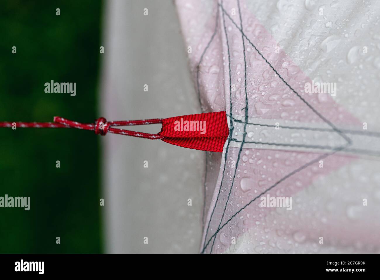 Loop on the awning of a wet tourist tent with a stretched rope in a ...