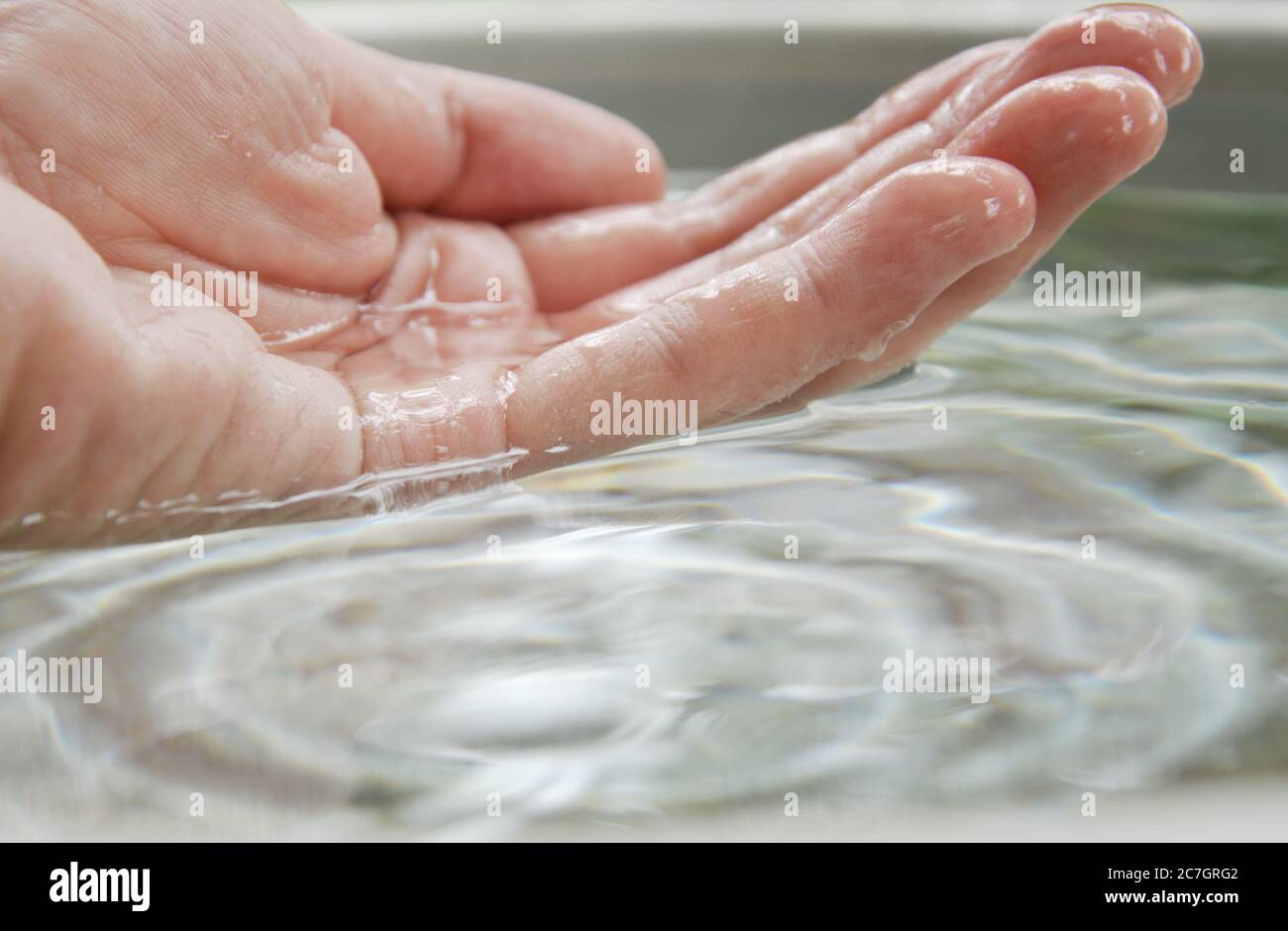 human hand bailing water in stainless basin Stock Photo - Alamy
