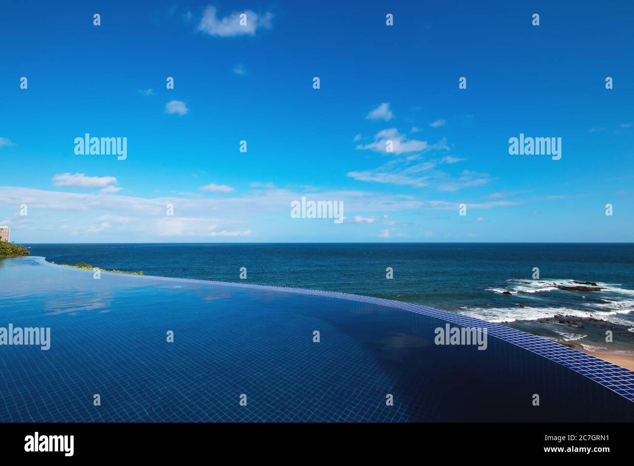 Infinity pool with views of the sea and blue sky Stock Photo - Alamy