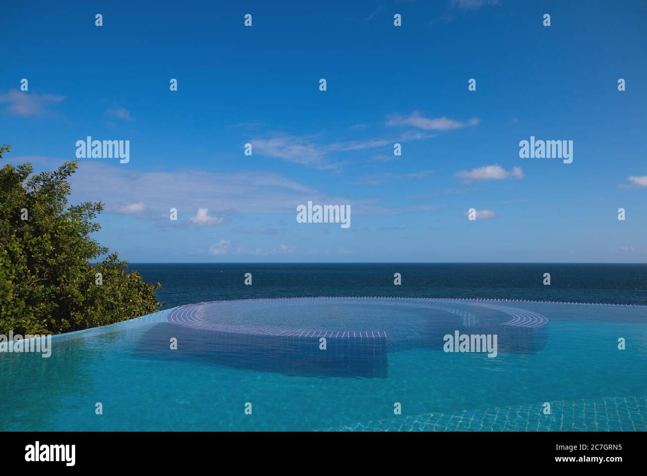 Infinity pool with views of the sea and blue sky Stock Photo - Alamy