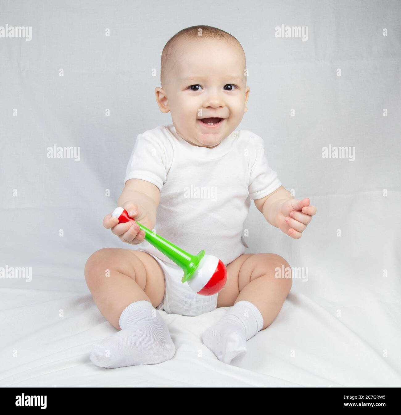 Photo of a eight month old baby with rattle Stock Photo - Alamy