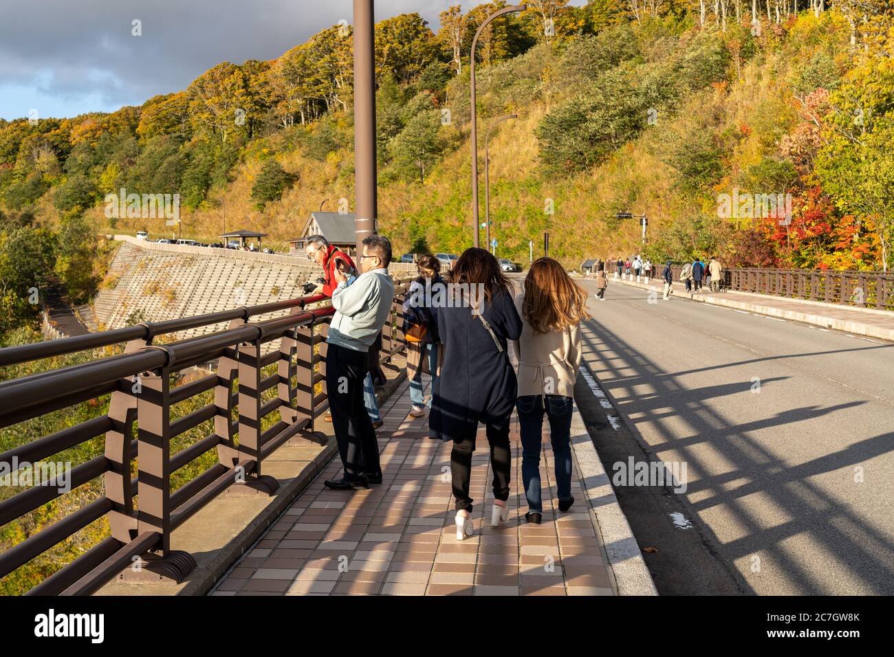 Tourists sightseeing on the Jogakura Ohashi Bridge during autumn ...