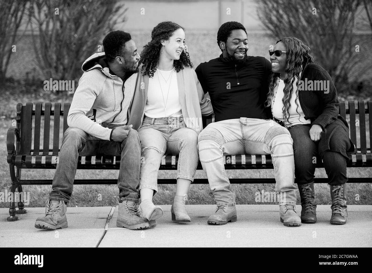 Group of young people park bench Black and White Stock Photos & Images ...