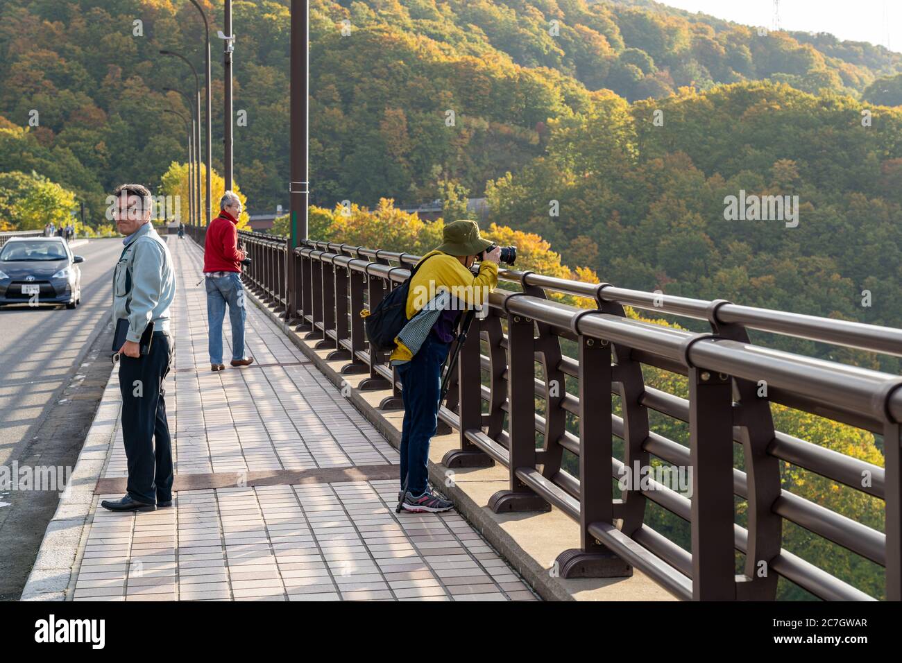 Tourists sightseeing on the Jogakura Ohashi Bridge during autumn ...
