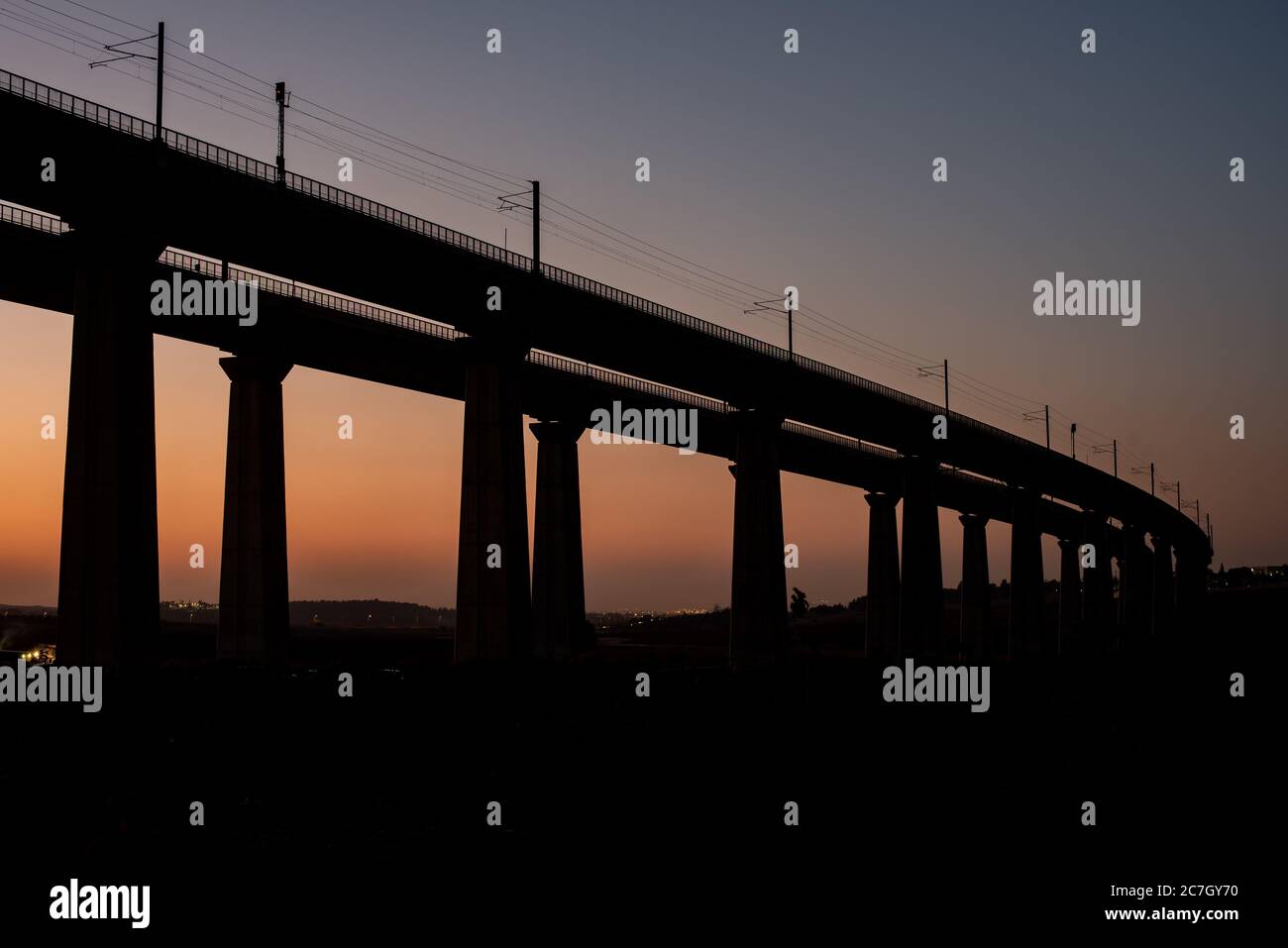 Concrete bridge with a town on the blurry background during a beautiful ...