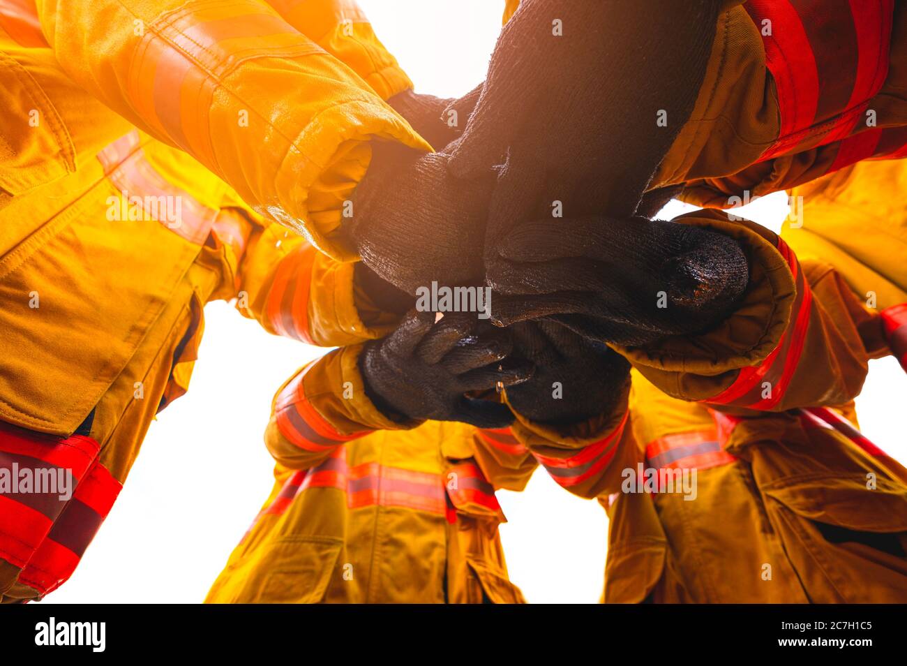 Firefighter putting hands up for fire fighting, Cheerful people giving ...