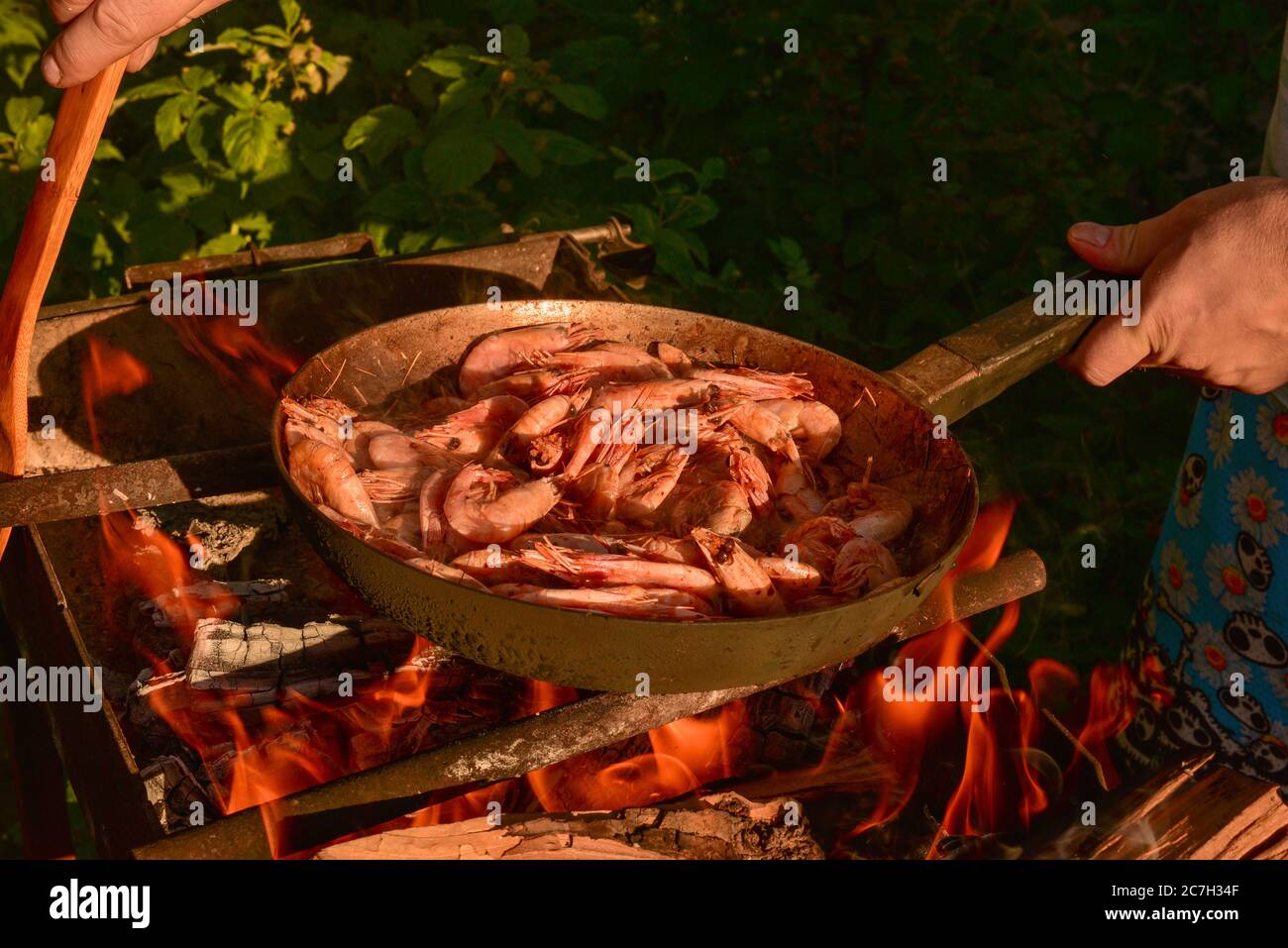 shrimp. Shrimps are cooked in a pan over a fire. Bonfire seafood Stock ...
