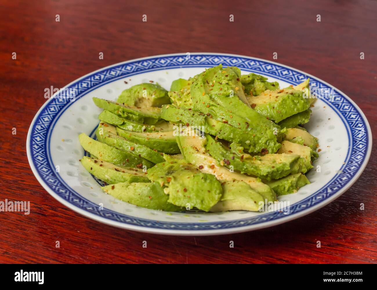 Avocado salad with pepper and lemon juice on a chinese plate Stock ...