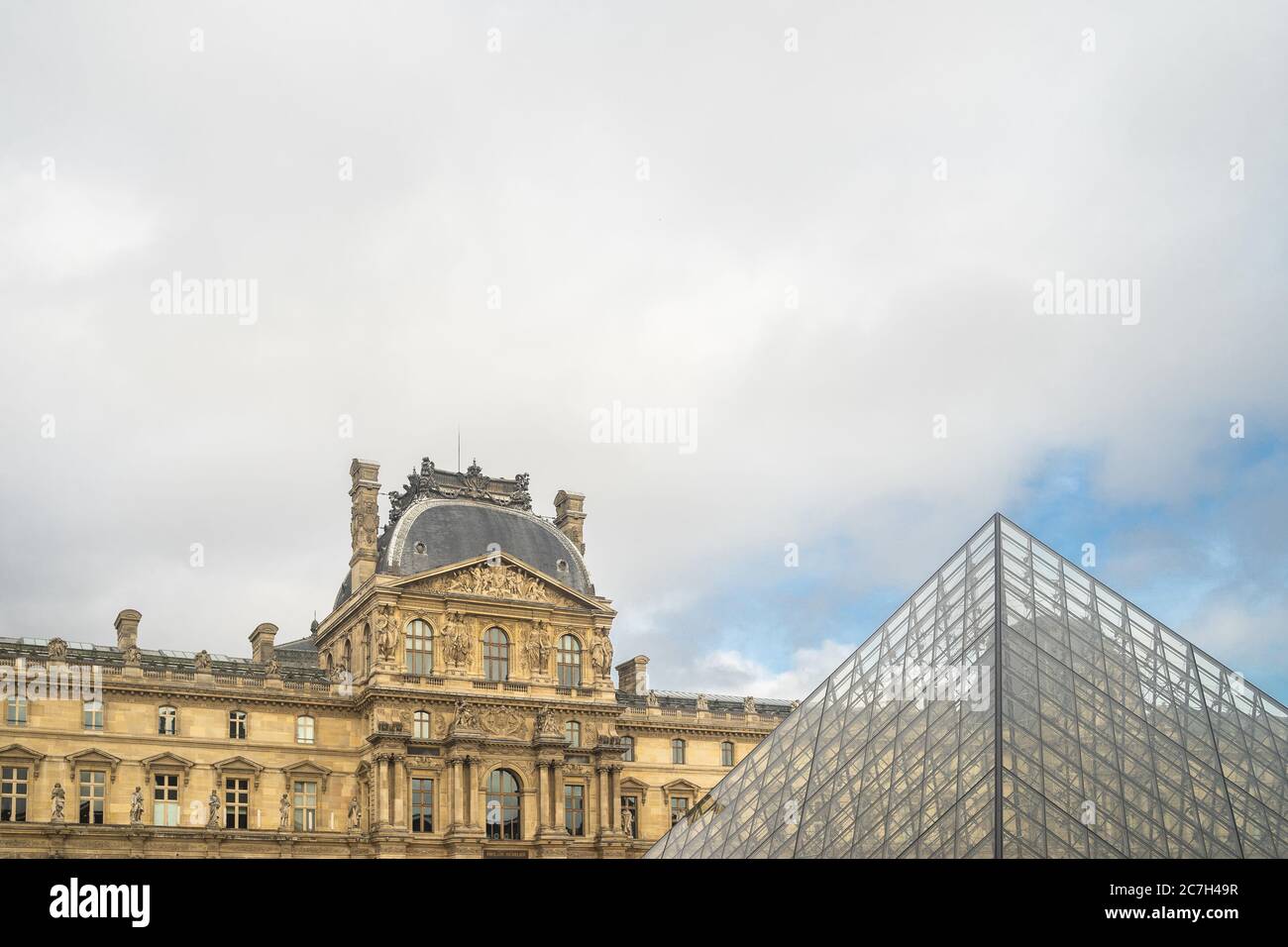 Louvre Museum under a cloudy sky during daytime in Paris in France ...