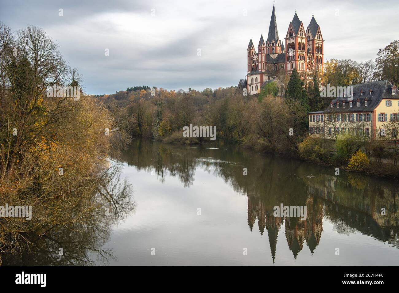 Limburg cathedral surrounded by greenery reflecting on the river under ...