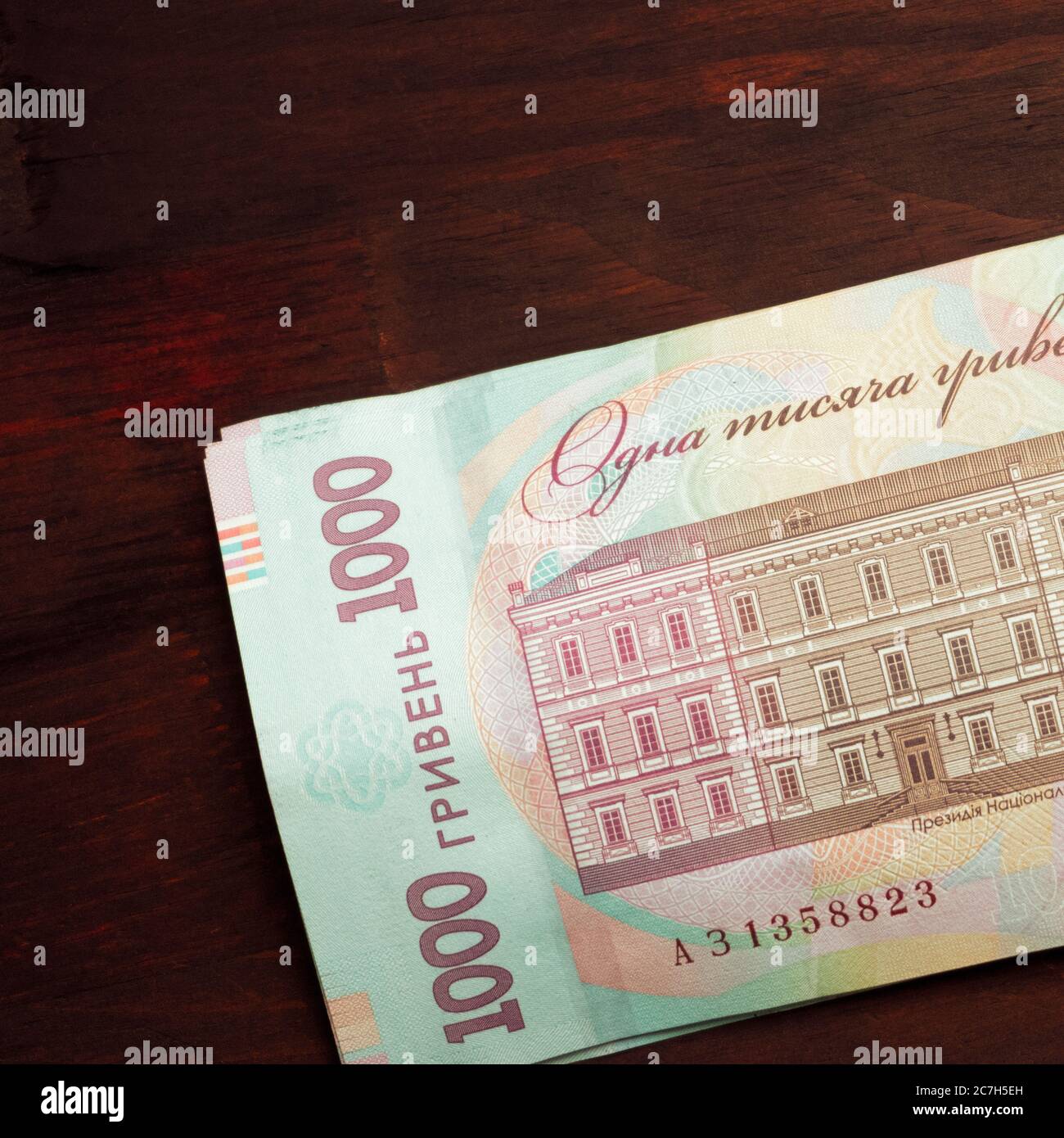 Paper money 1000 hryvnias on wooden table. Cash money concept. Close up ...