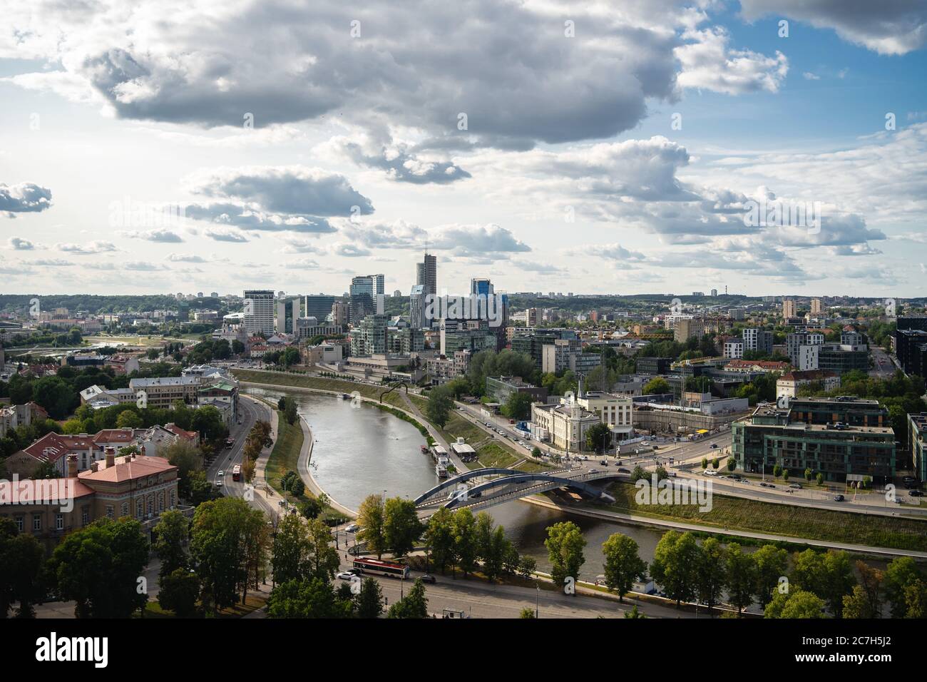 Vilnius city surrounded by buildings and greenery under sunlight and a ...