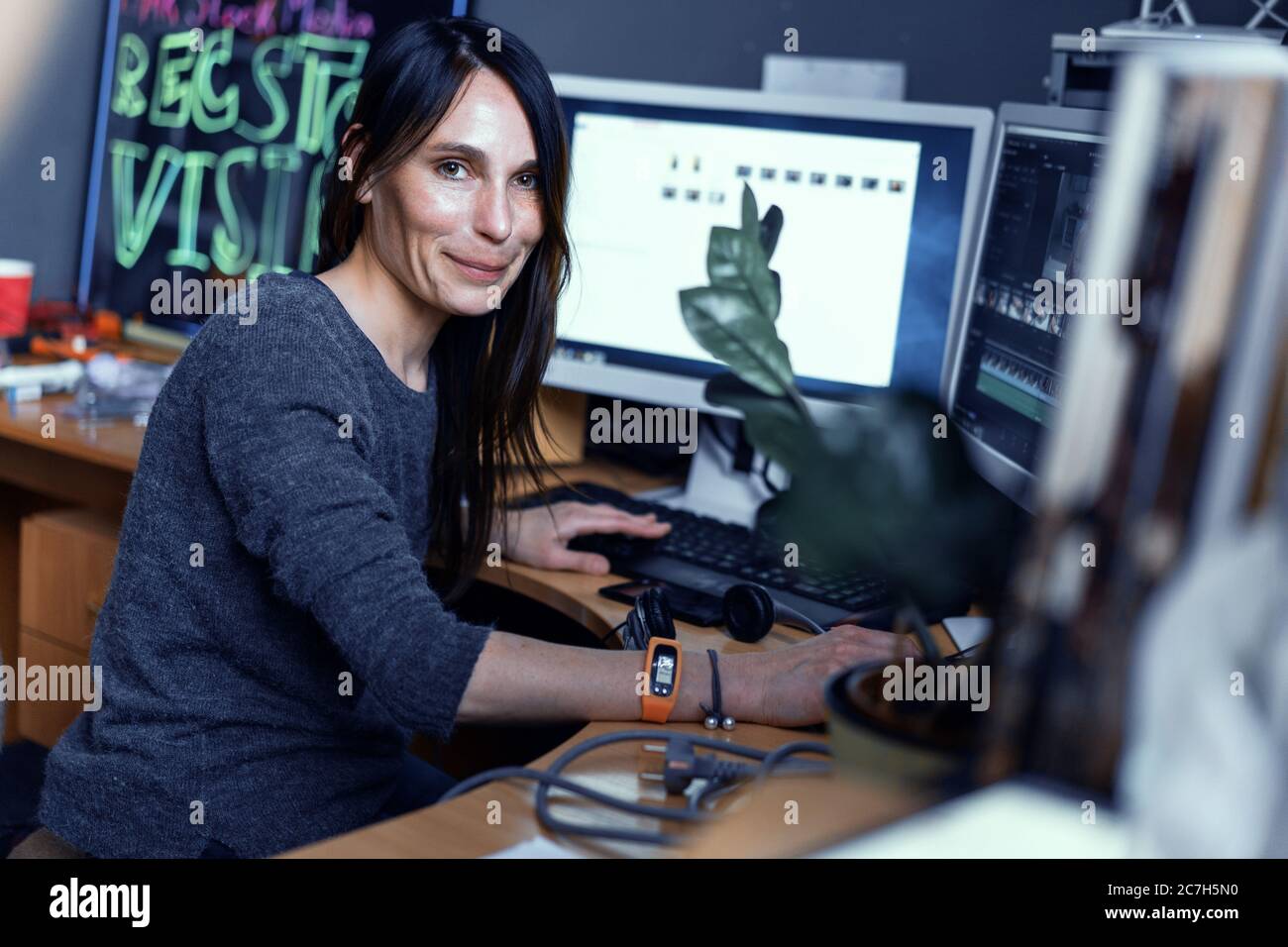 Cute Young Woman Video Editor Freelancer With Dark Hair Works On ...