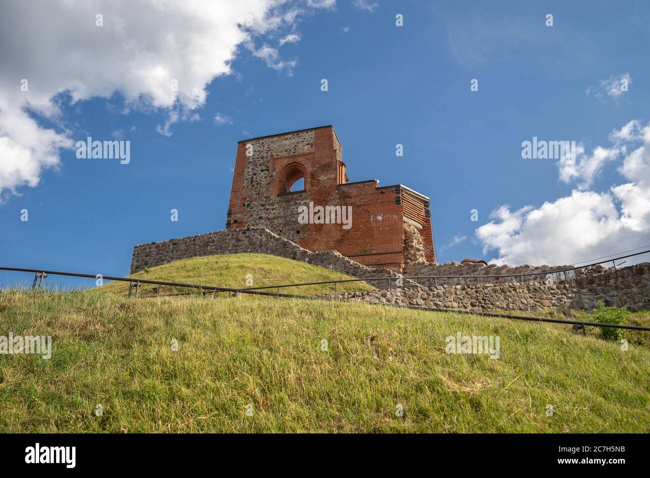Gediminas Castle Tower on a hill covered in greenery under sunlight in ...