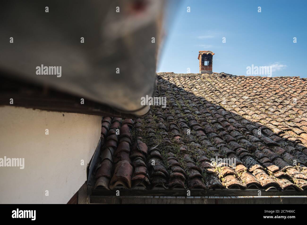 Old rusty roof covered in mosses under sunlight and a blue sky Stock ...