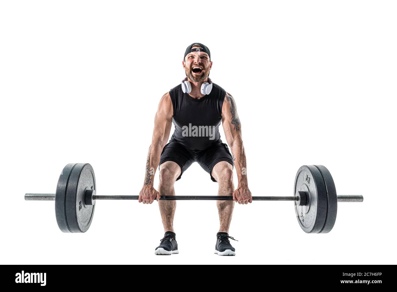 Aggressive bearded strong muscular Man in sportswear and headphones ...