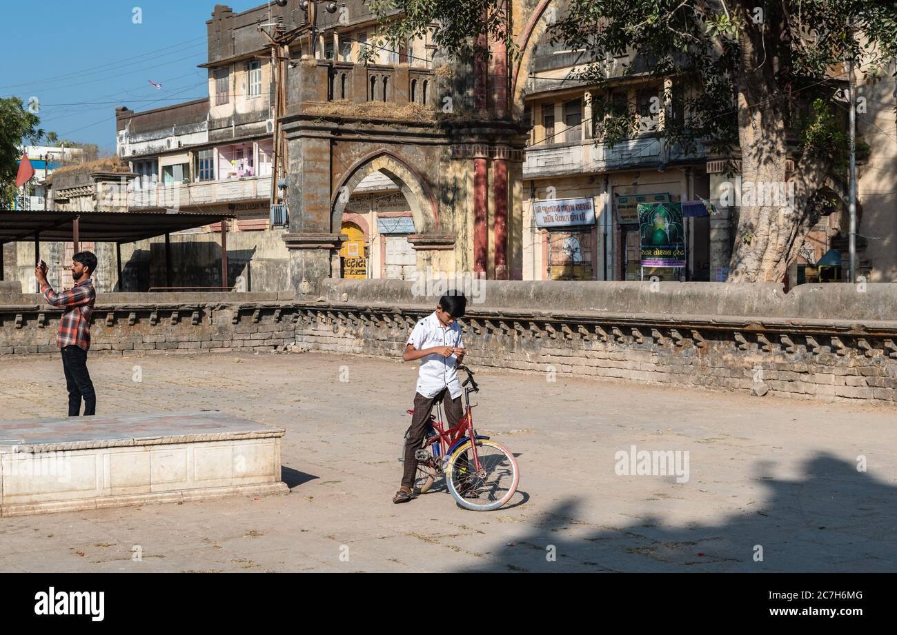 Junagadh, Gujarat, India - December 2018: A young boy stands with his ...