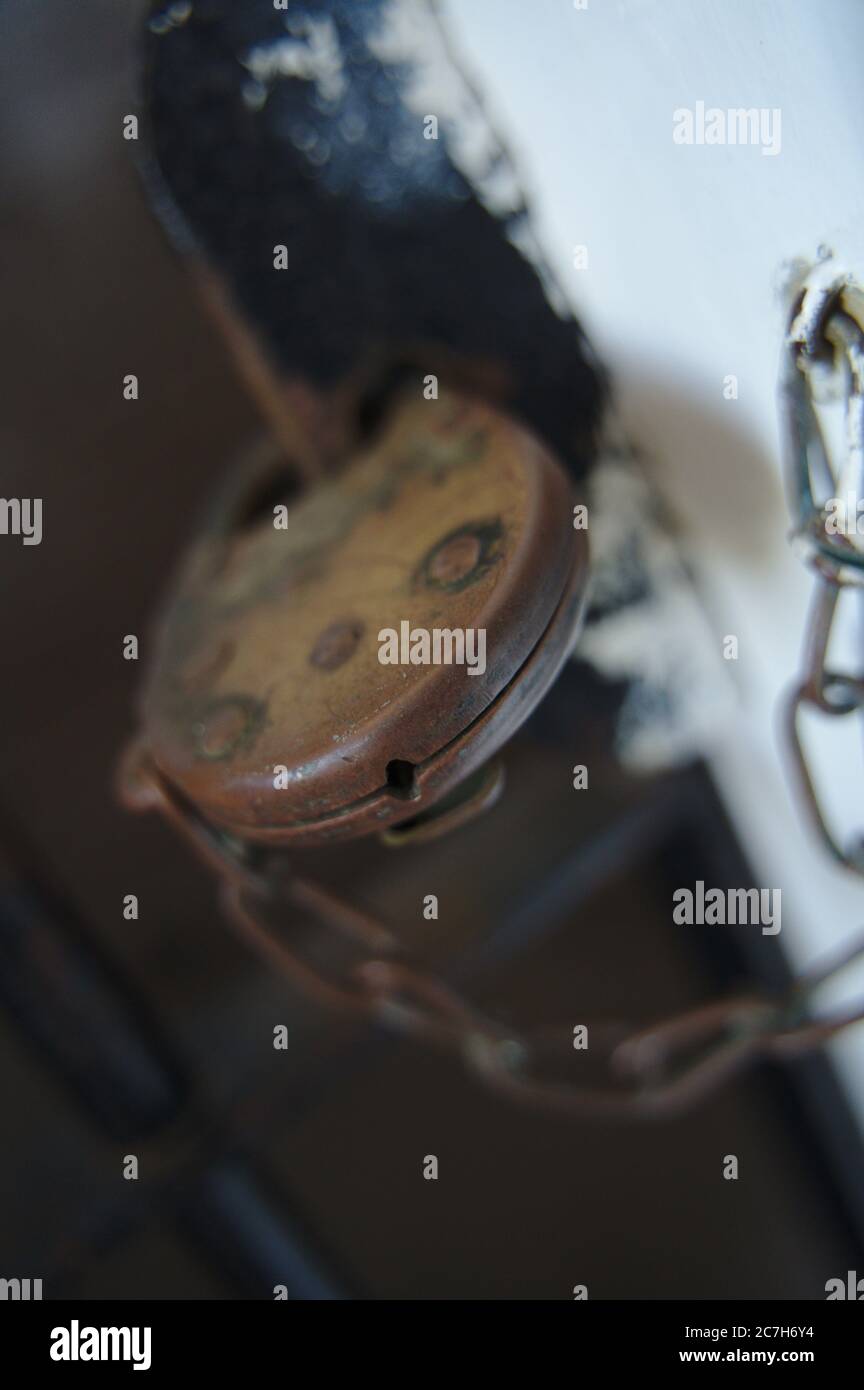 Closeup of an old rusty lock on a metallic door with a blurry ...