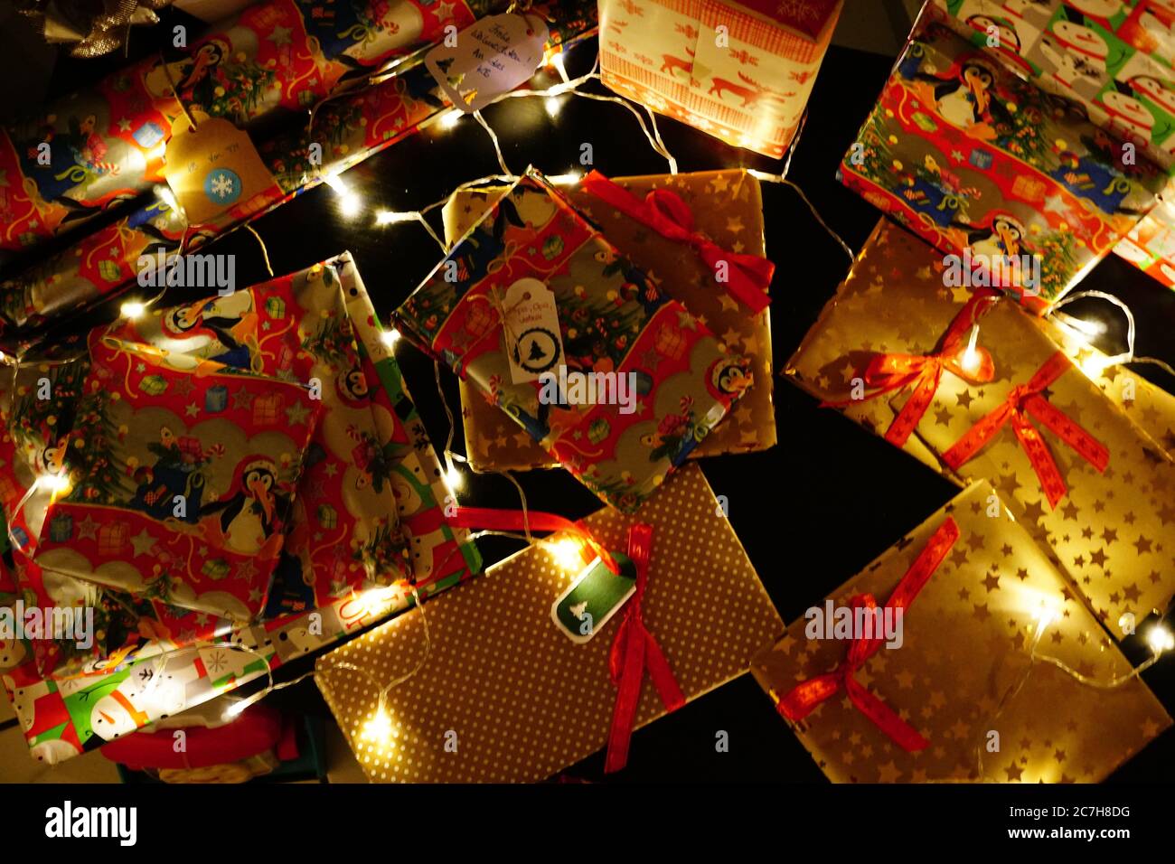 High-angle shot of different Christmas gifts with illuminated lights on ...