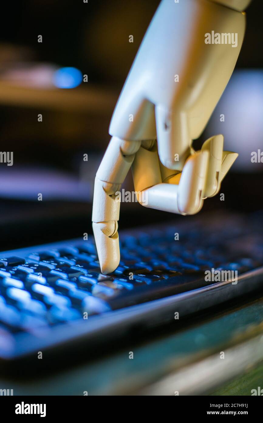 robotic hand typing on a computer keyboard Stock Photo - Alamy
