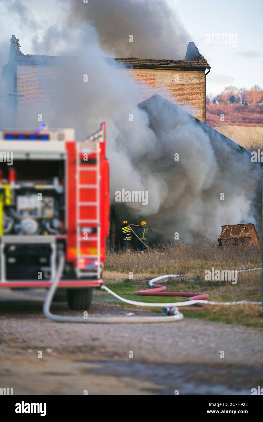 firemen extinguishing a burning house Stock Photo - Alamy