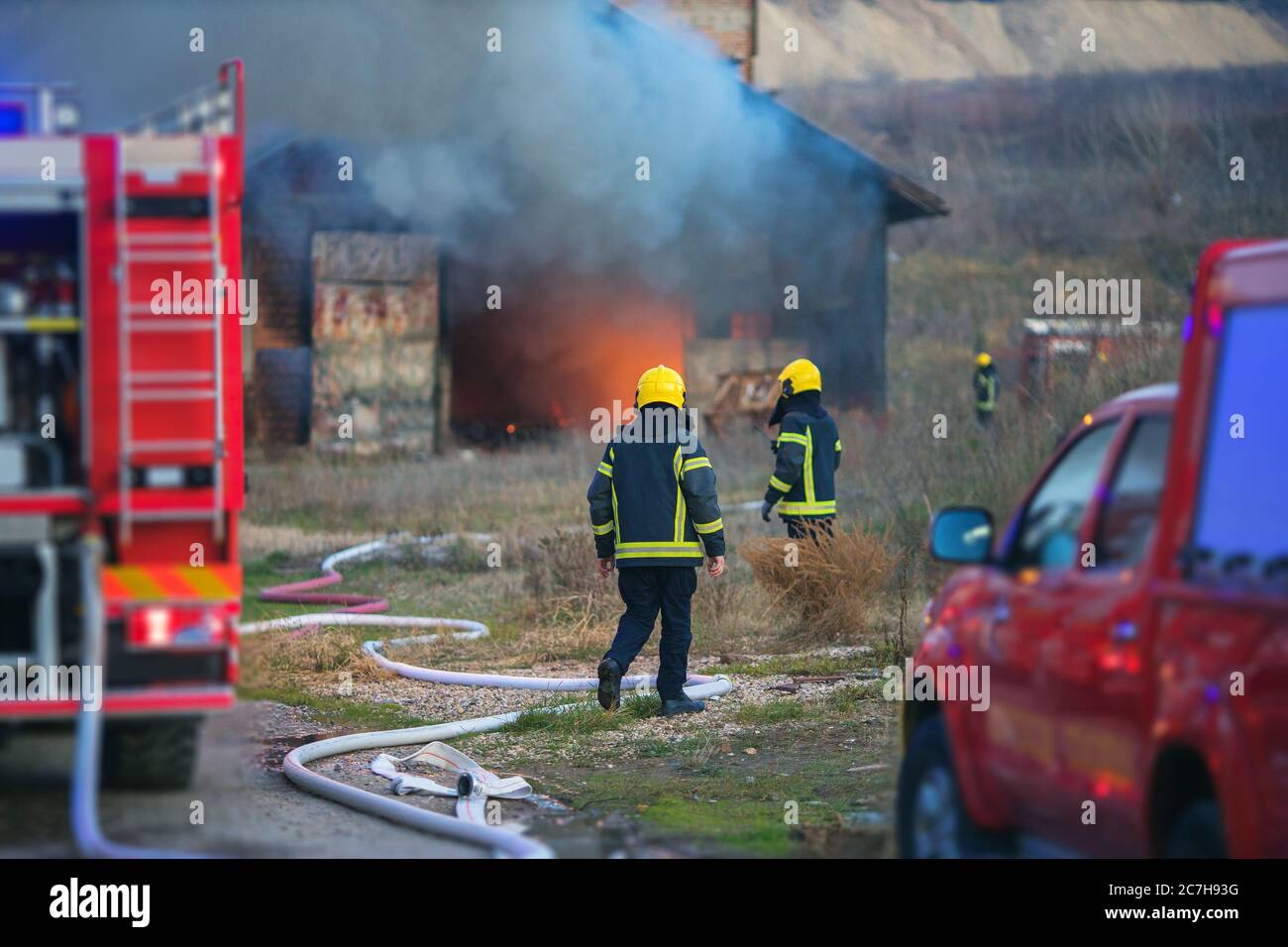 firemen extinguishing a burning house Stock Photo - Alamy